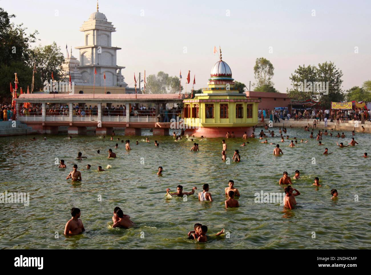 Hindu devotees bathe in a pond at the shrine of Baba Sidh Goria in ...