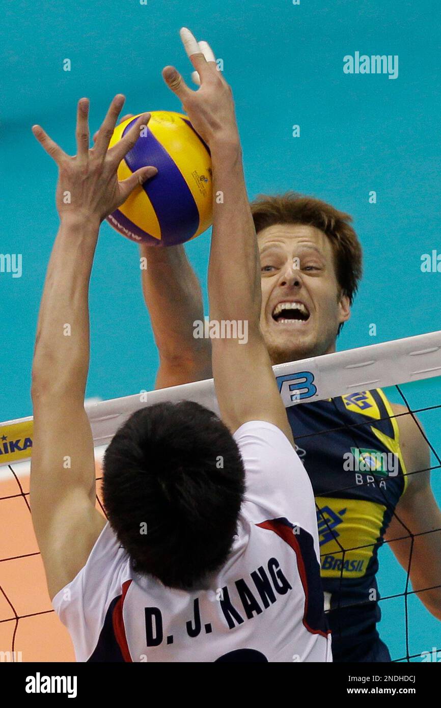 Brazil's Murilo Endres, right, spikes the ball against South Korea's ...