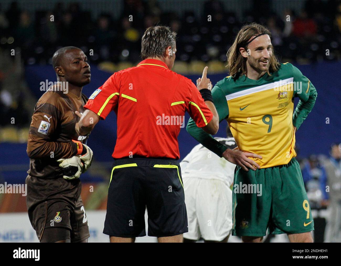 Italian referee Roberto Rosetti, center, warns Australia's Josh Kennedy ...