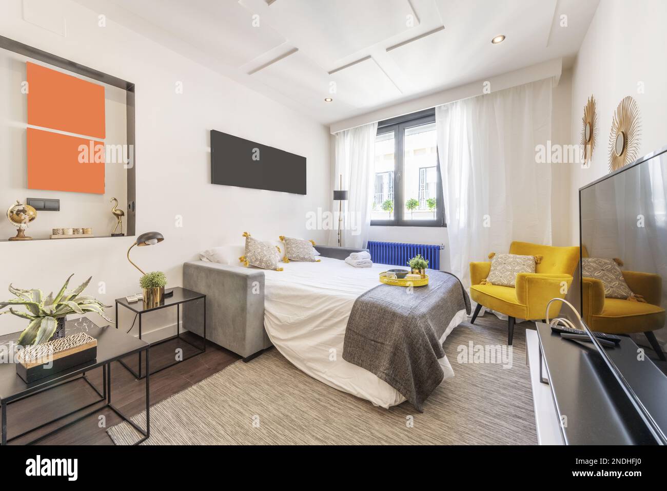 Living room of a house furnished with a sofa bed unfolded with a ...