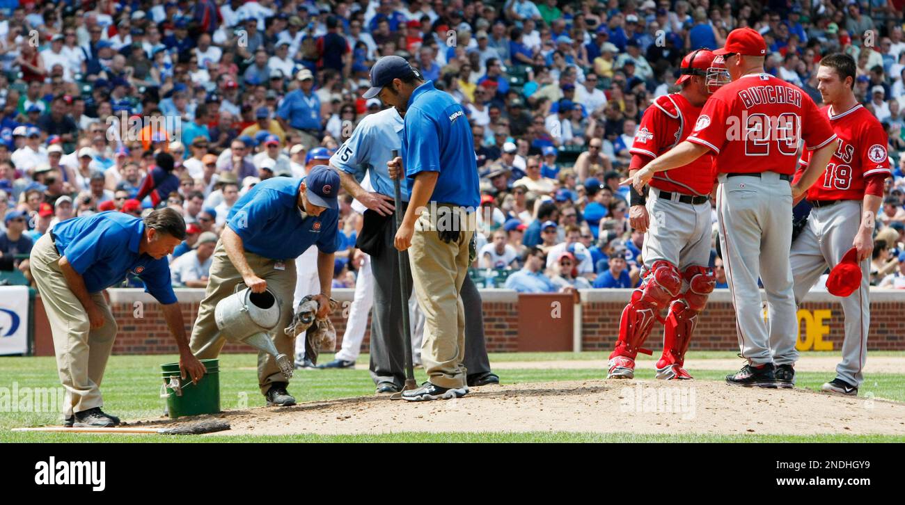 Los Angeles Angels pitching coach Mike Butcher (23) points out where ...