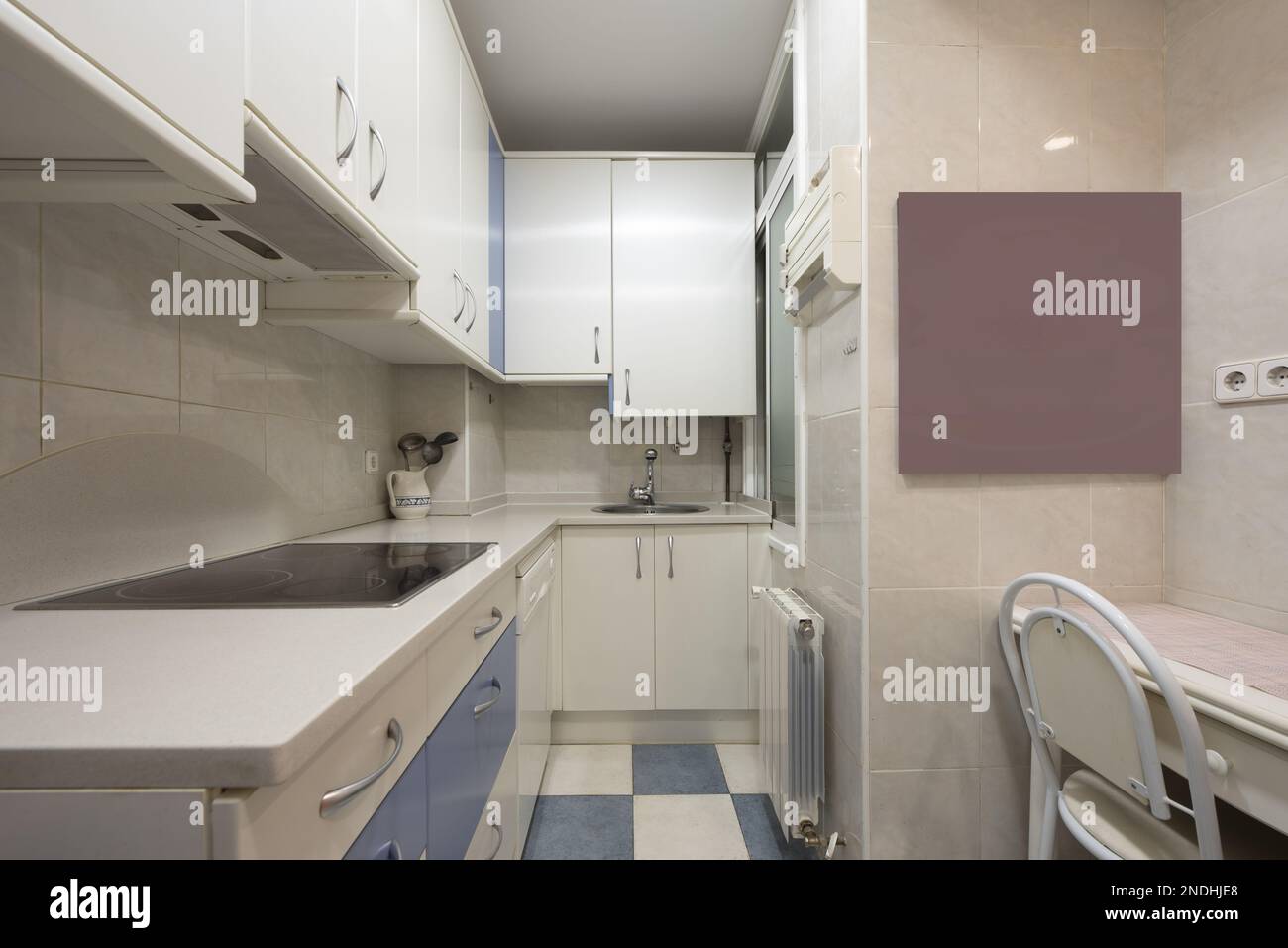 kitchen with white cabinets and blue details with white stone ...