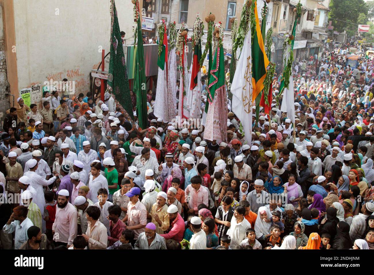 Indian pilgrims participate in a procession going to visit a shrine, in ...