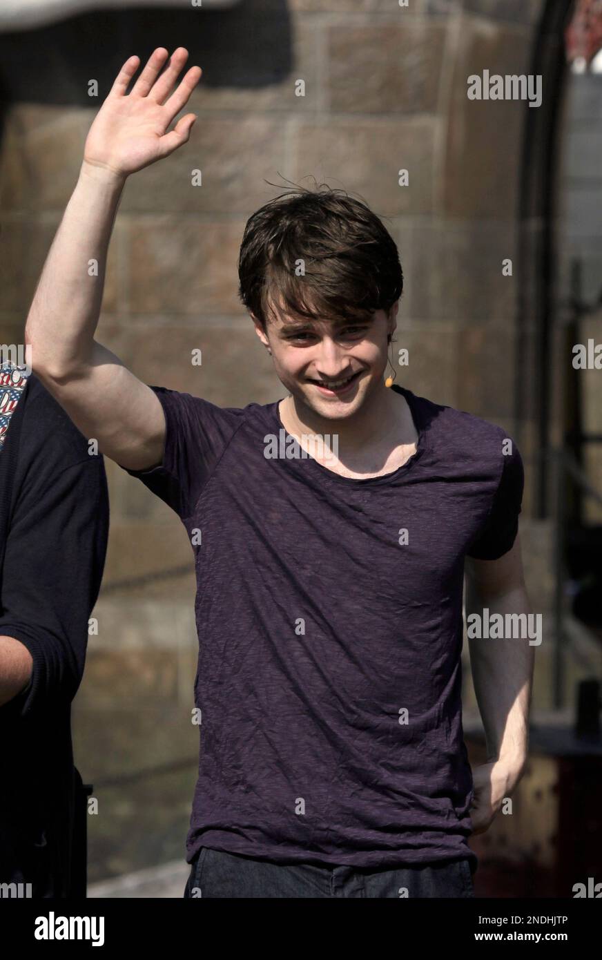 Daniel Radcliffe waves to fans during grand opening ceremonies of the ...