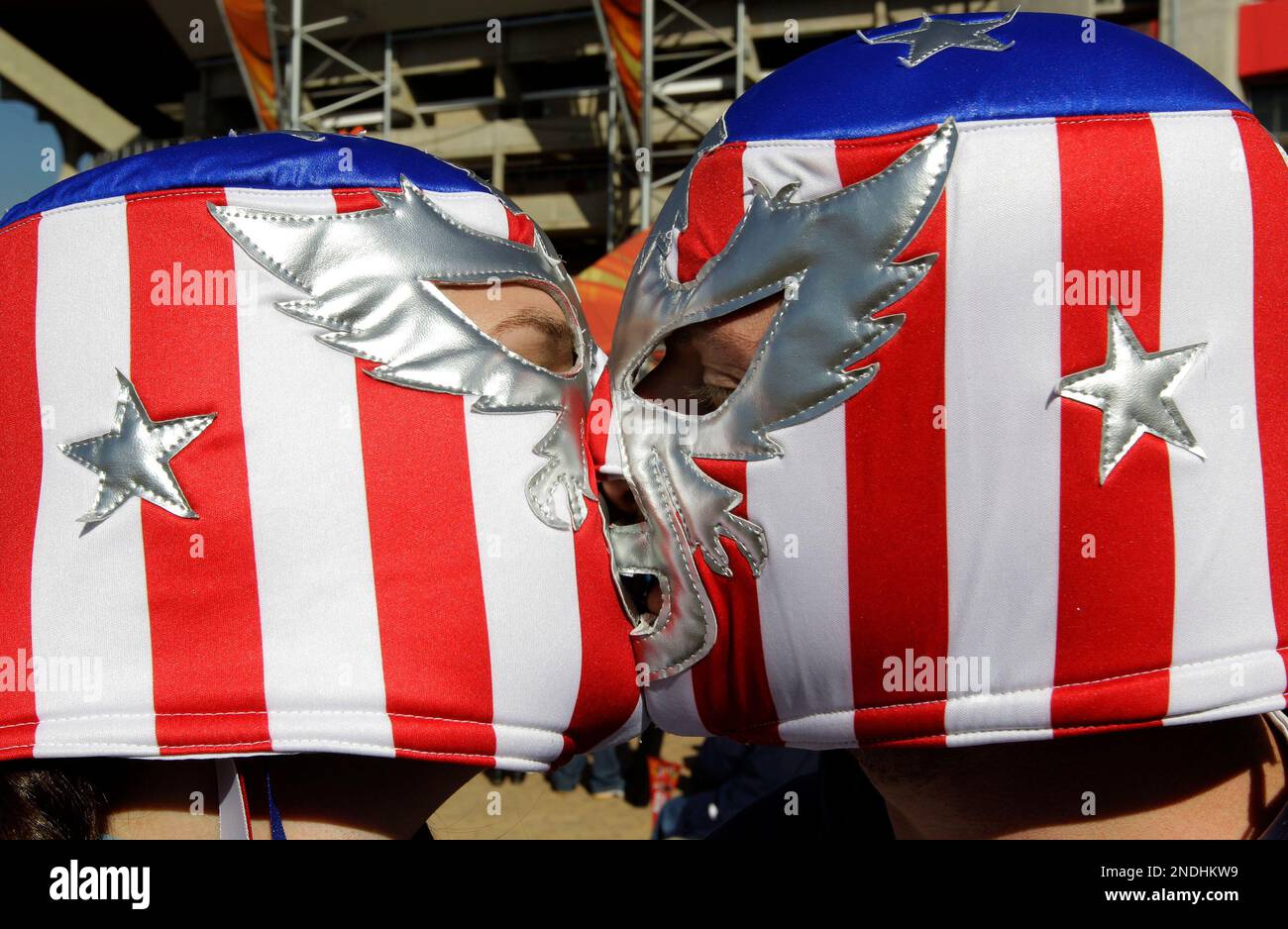A United States couple fans, kiss each other as they arrive at Ellis ...