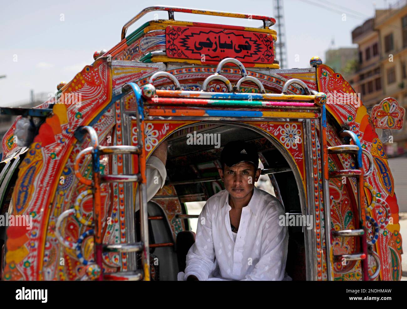 A Pakistani man sits inside a public bus in Rawalpindi, Pakistan ...