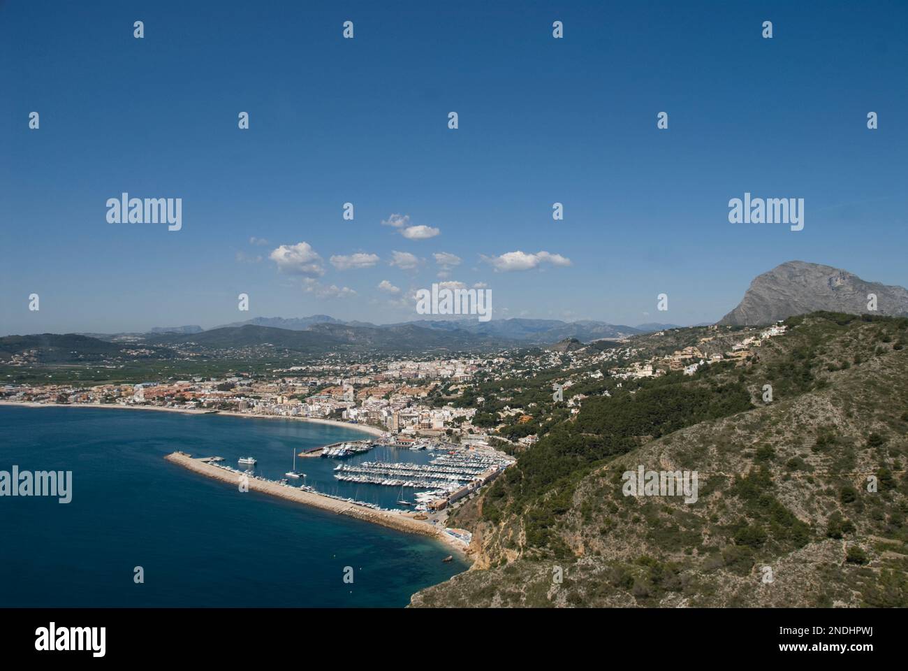 Scenic view of beach, harbour with boats and town, Javea, between ...