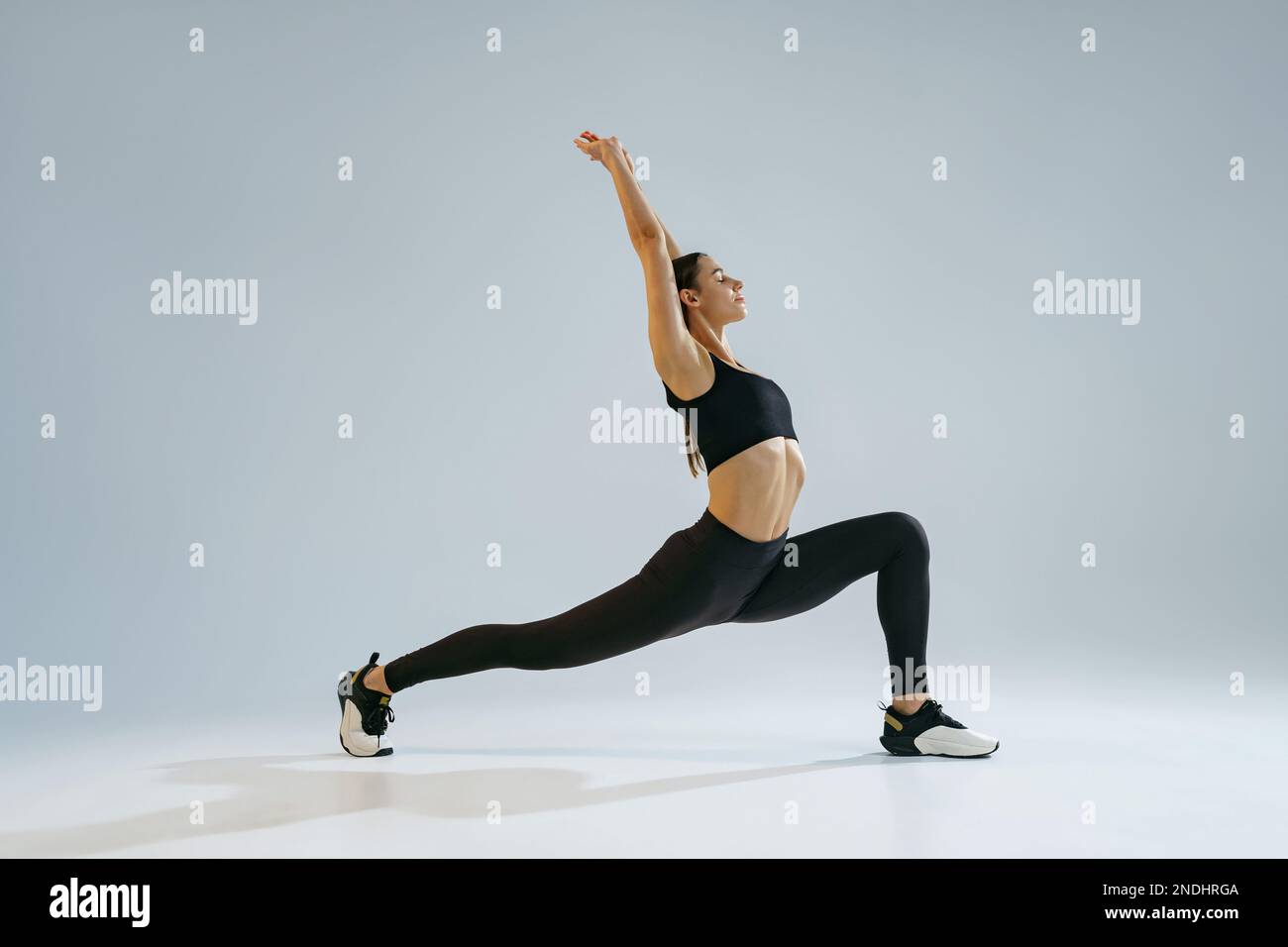Flexible woman doing stretching exercises on studio background. Healthy ...