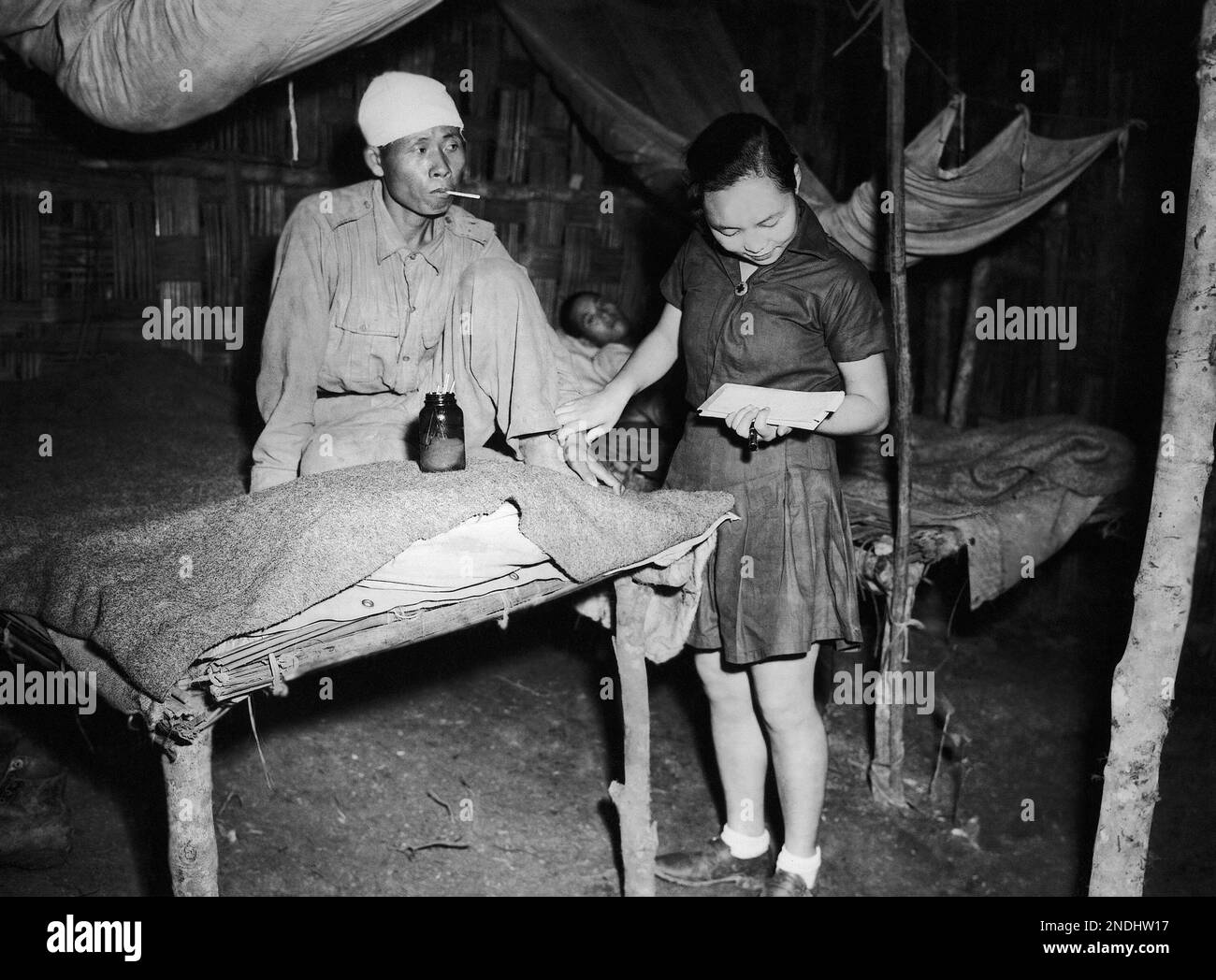 Gawlu Kaw Nau takes temperatures and pulse of Chinese soldier suffering from scalp injury at ...