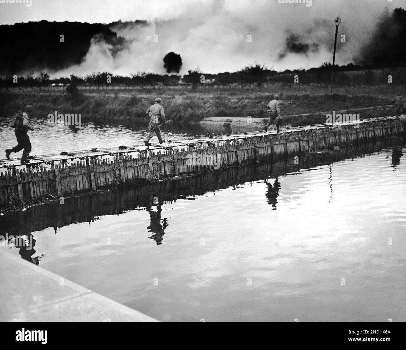 Troops of an Infantry division are crossing the Meuse River in Belgium ...
