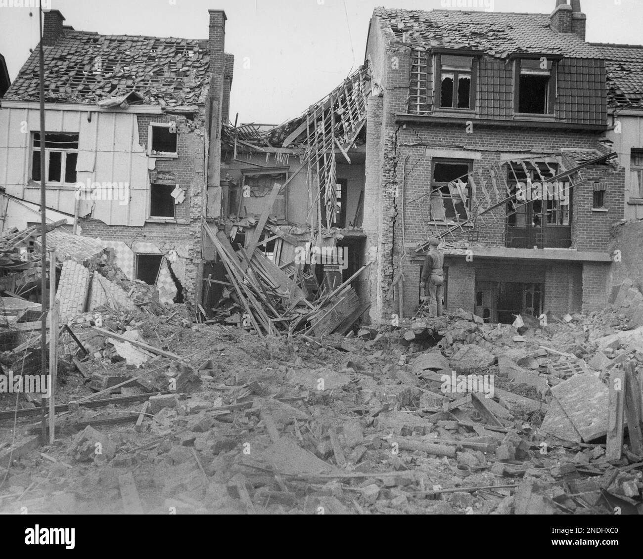 Damage done by German bombs, and Belgian civilians being evacuated from ...