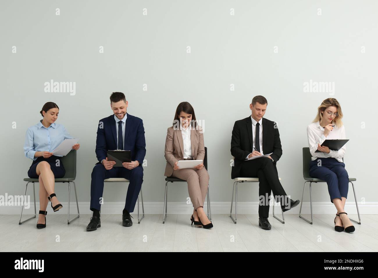 People waiting for job interview in office hall Stock Photo - Alamy