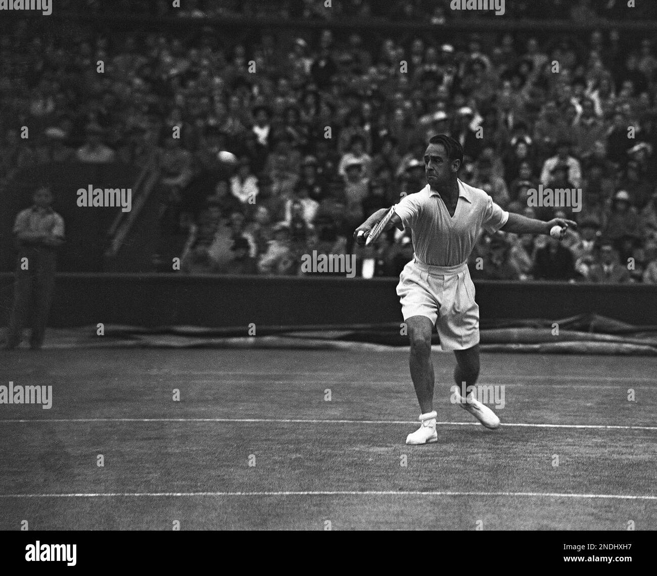 Australian tennis player Adrian Quist in play against Henry Wilfred ...