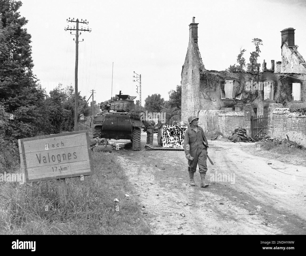 Americans passing through St. Mere Englise, France on June 12, 1944 ...