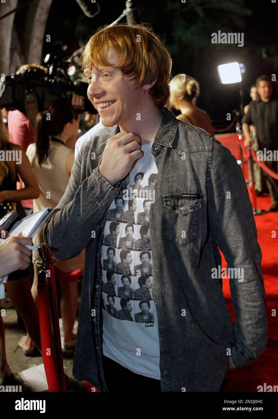Actor Rupert Grint greets fans during part of the grand opening ...