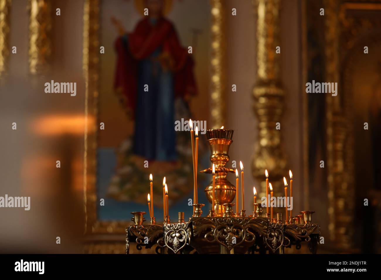 Beautiful stand with burning candles in church. Baptism ceremony Stock ...