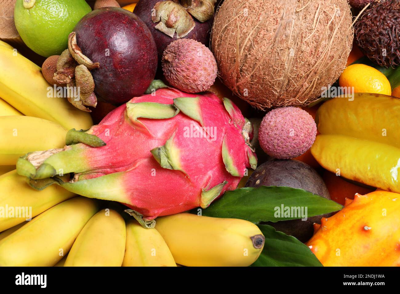 Different tropical fruits as background, closeup view Stock Photo - Alamy