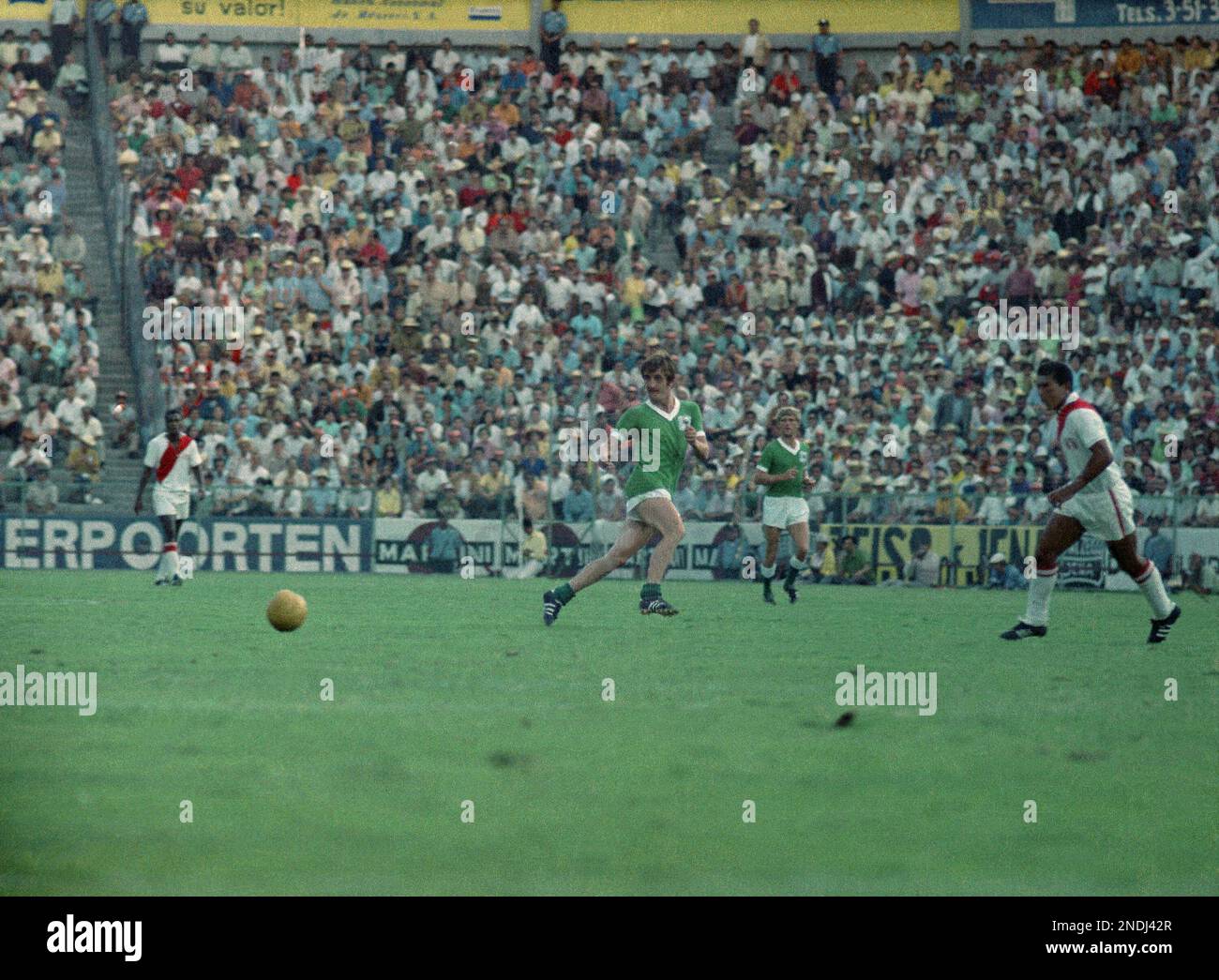 An unidentified German player runs with an unknown Peruvian player ...