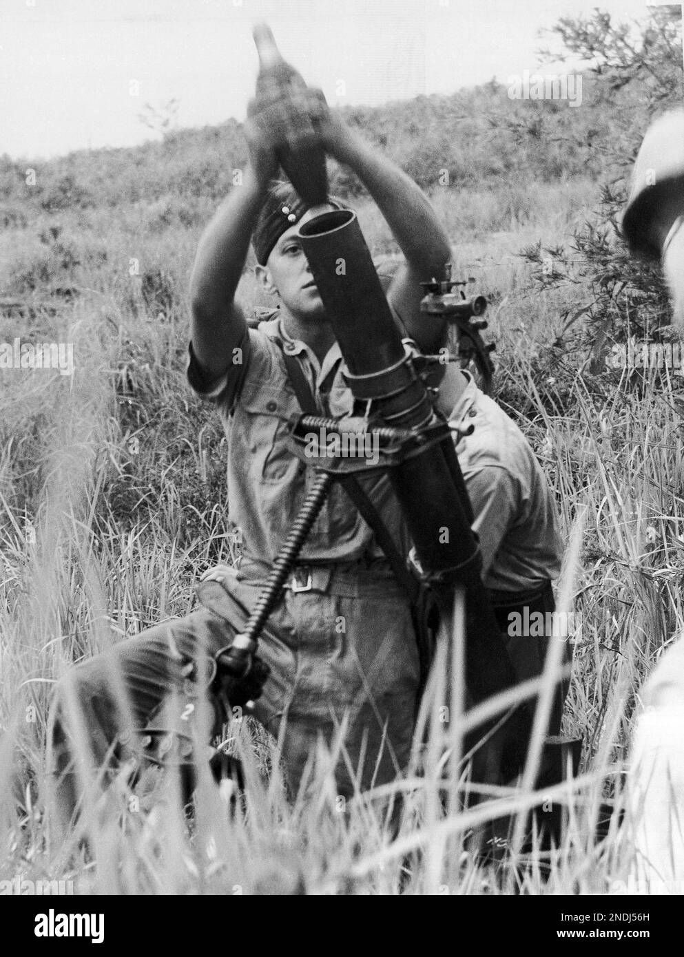 Members of British Imperial forces load a field mortar in a Malayan ...