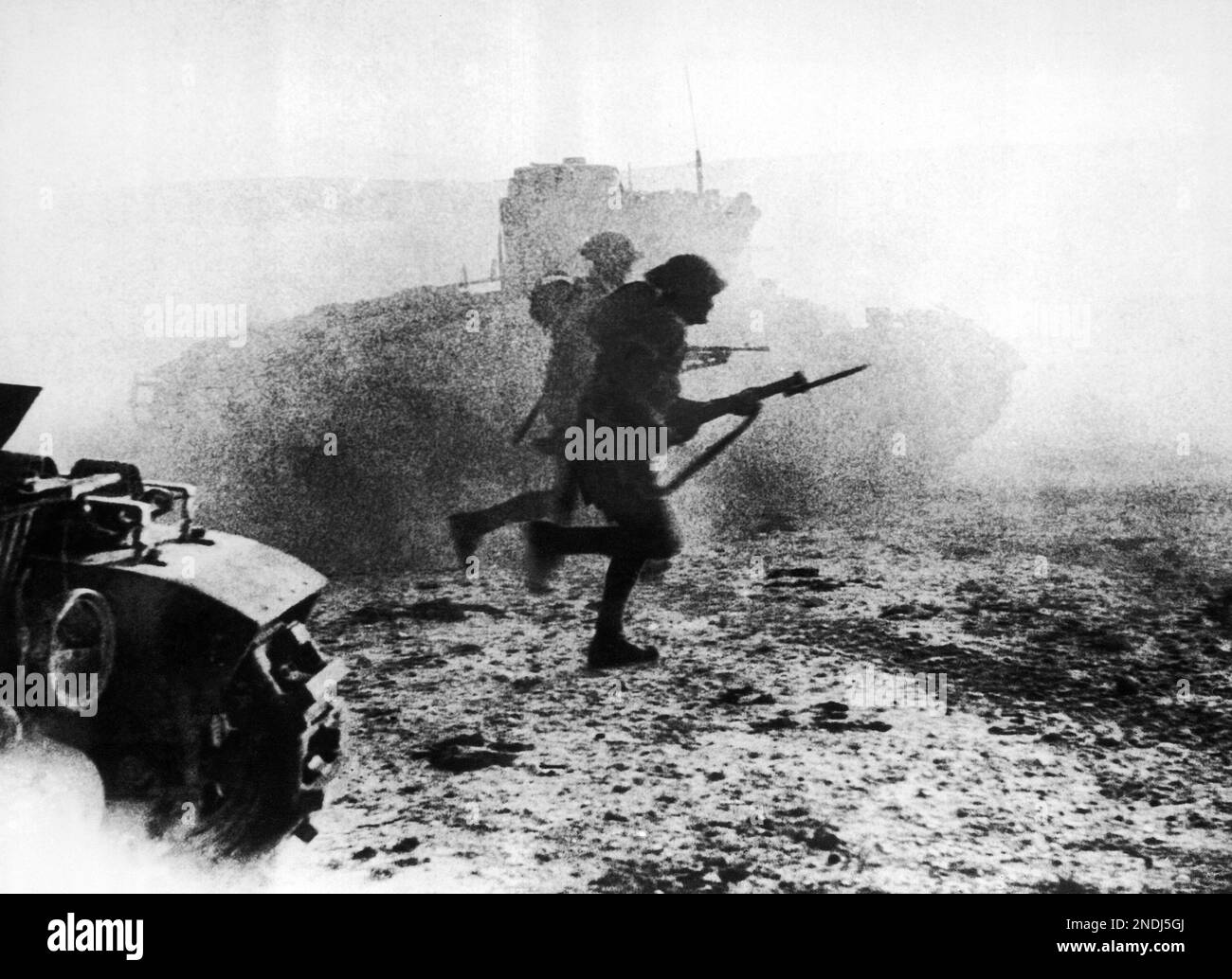 Flanked by tanks and under cover of a smoke screen as well as clouds of ...