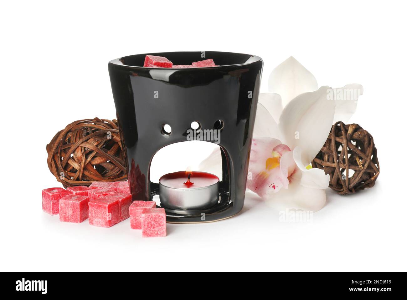 Stylish aroma lamp with essential wax cubes and flower on white ...