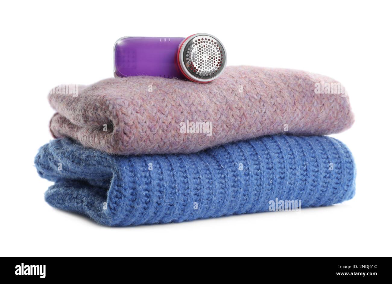 Modern fabric shaver and woolen clothes on white background Stock Photo ...