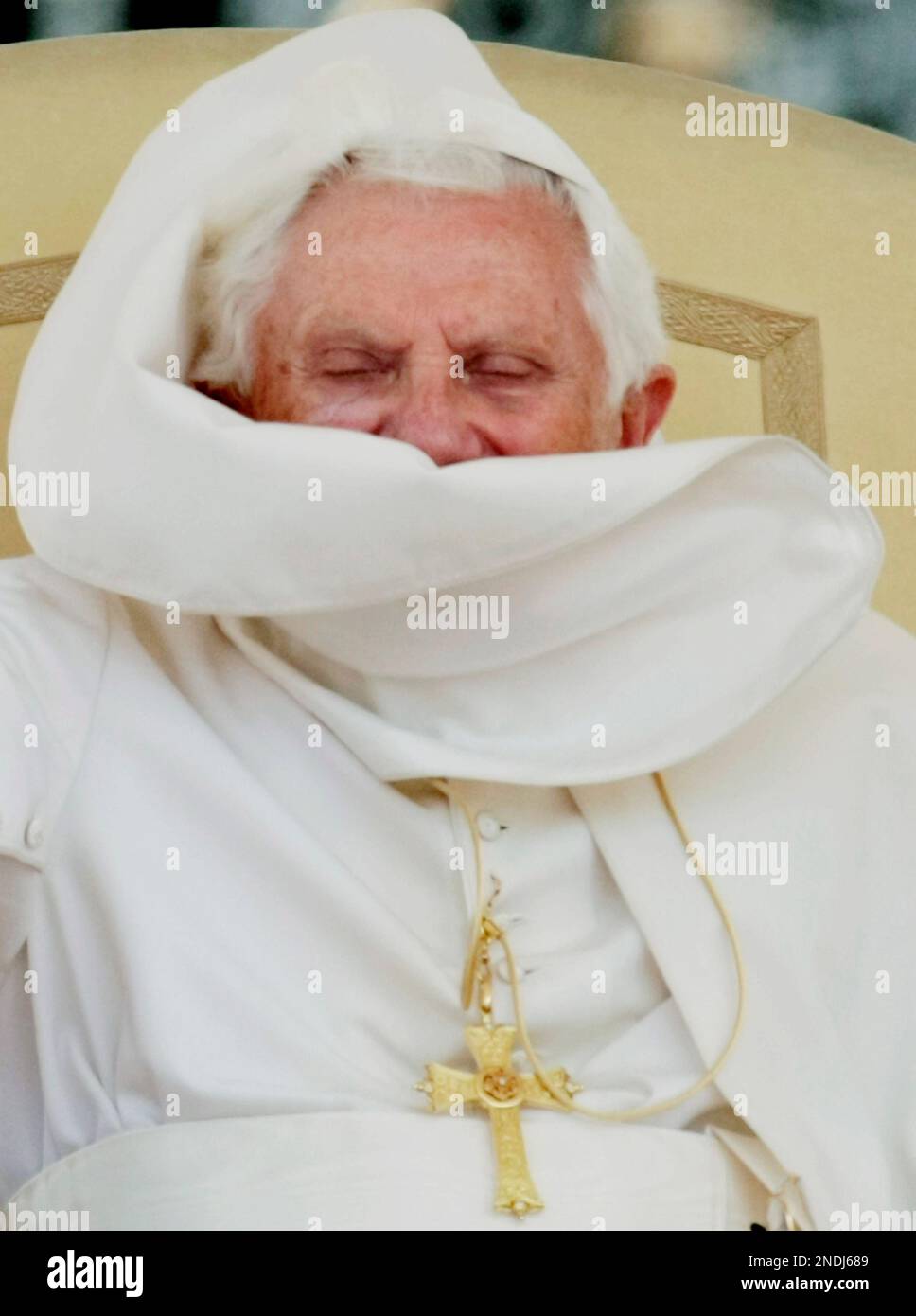 Pope Benedict XVI's mantle is blown by the wind during the weekly ...