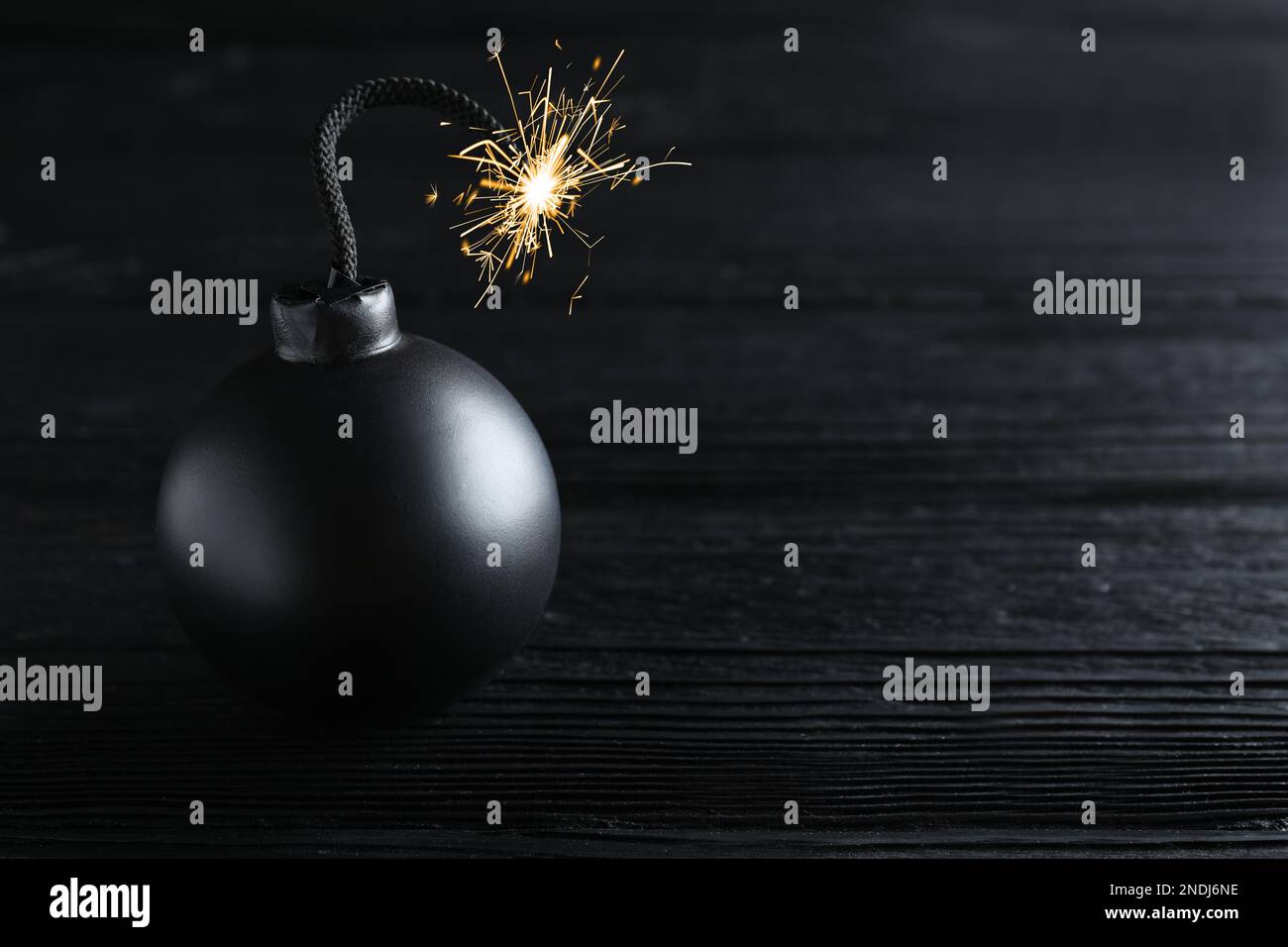 Old fashioned fuse bomb on black wooden table. Space for text Stock ...
