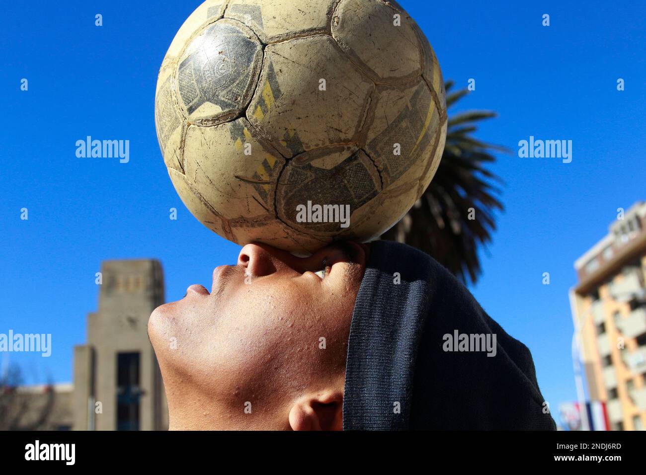 A South African street artist controls the ball with his face at the ...