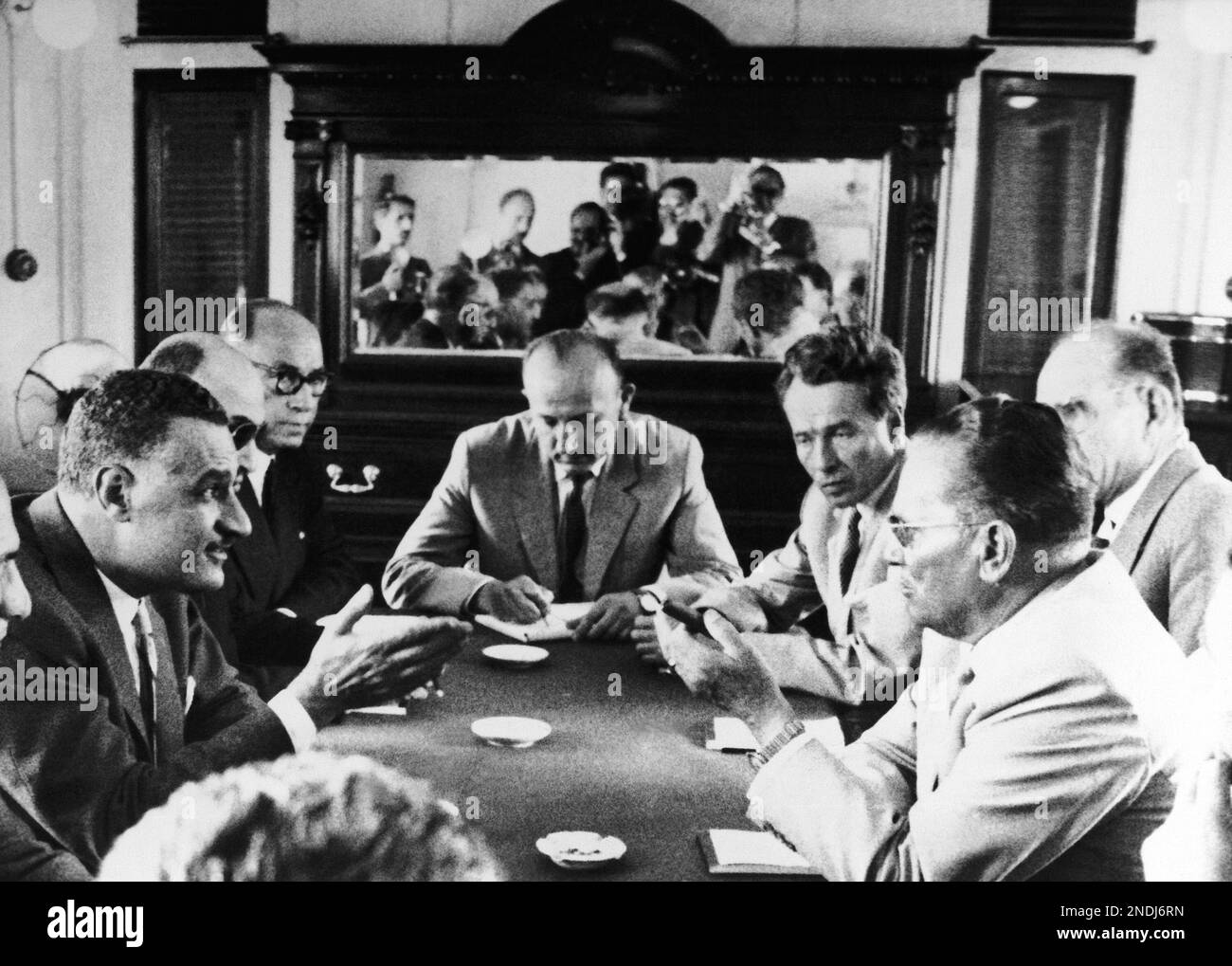 The conference is reflected in a mirror in the background as President ...