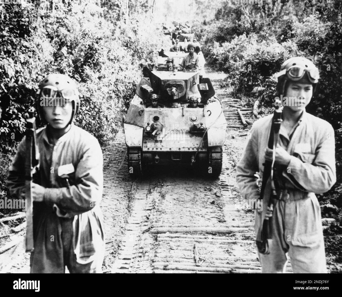 Chinese-manned American tanks advance down a road in the jungles of ...