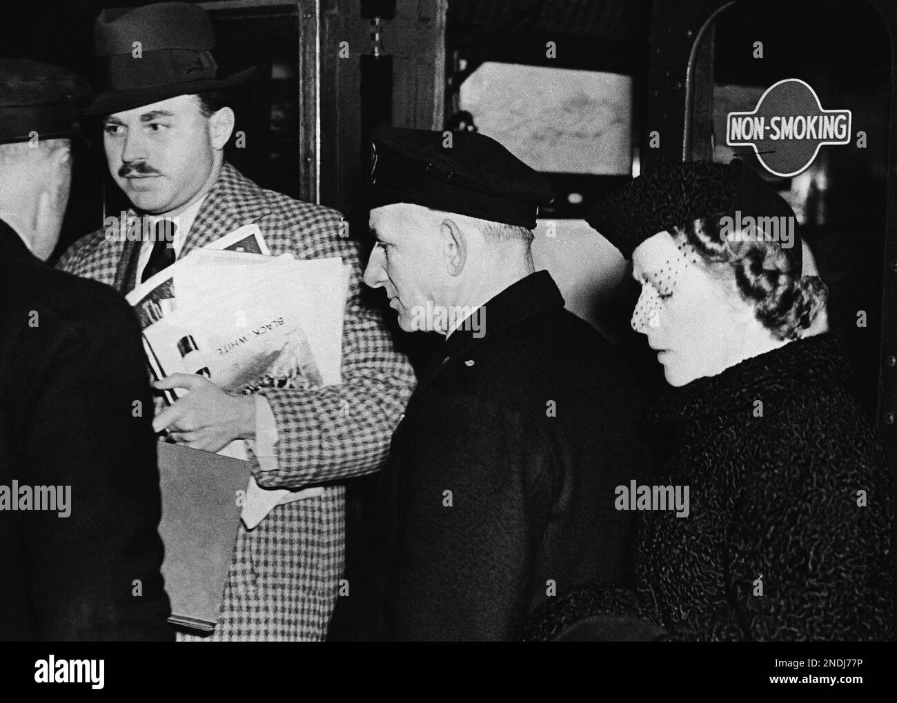 Ernest Simpson, left, holding papers, the divorced husband of Wallis ...