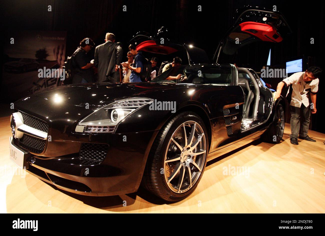 A man cleans a Mercedes-Benz SLS AMG sports car during its launch in ...
