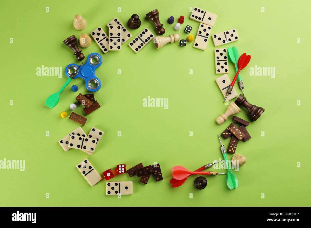 Frame of board games components on green background, flat lay. Space ...