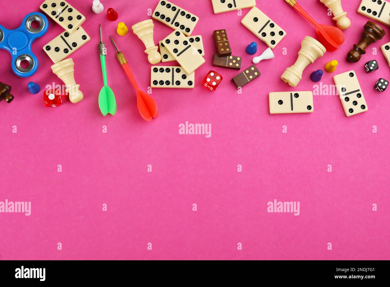 Components of board games on pink background, flat lay. Space for text ...