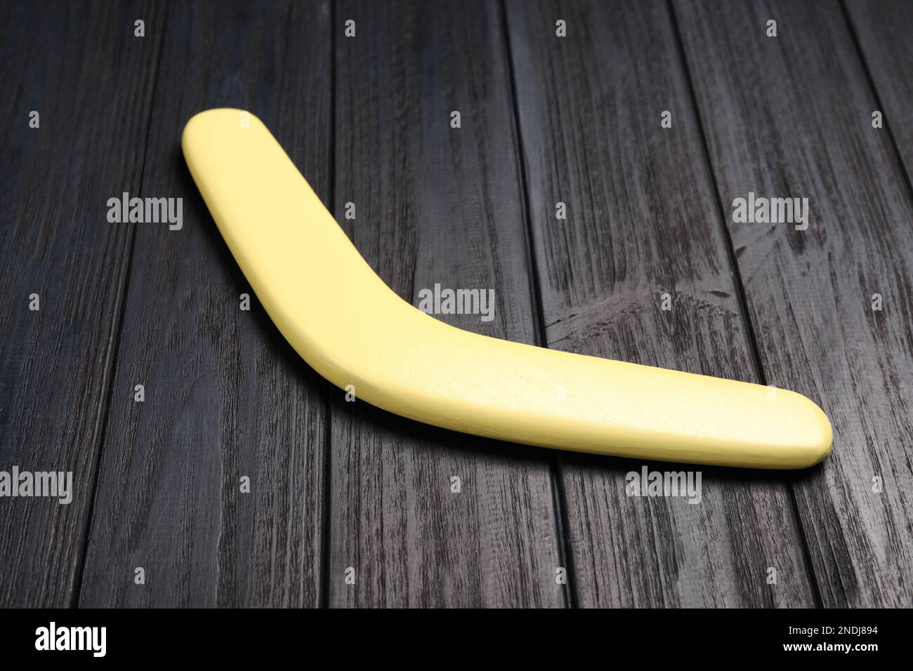 Boomerang on black wooden background. Outdoors activity Stock Photo - Alamy