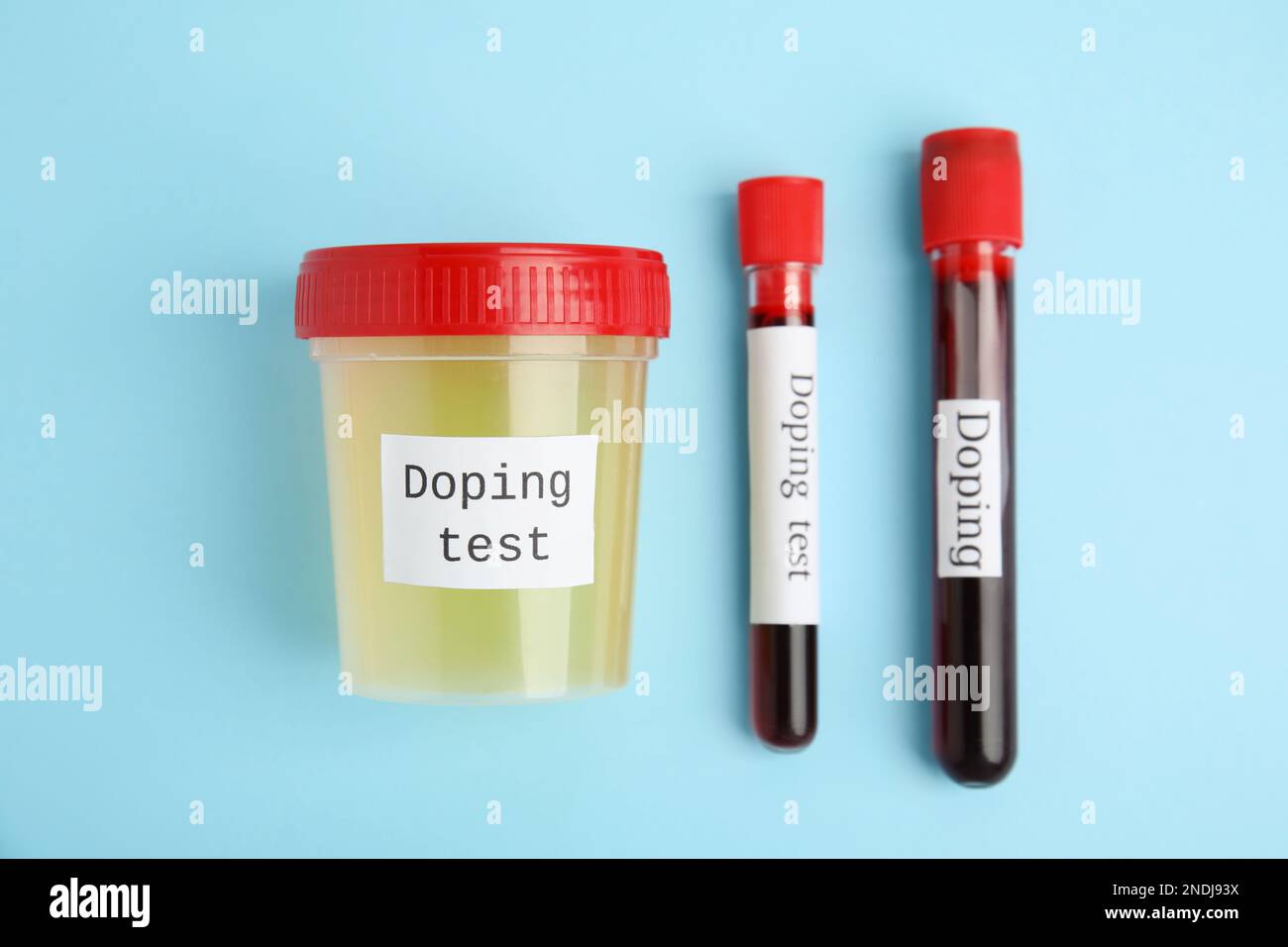 Jar and test tubes with samples on light blue background, flat lay ...