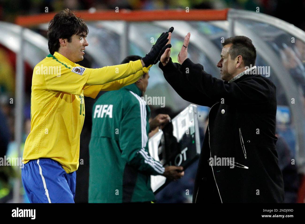 Brazil's Kaka, left, greets coach Dunga during the World Cup group G ...
