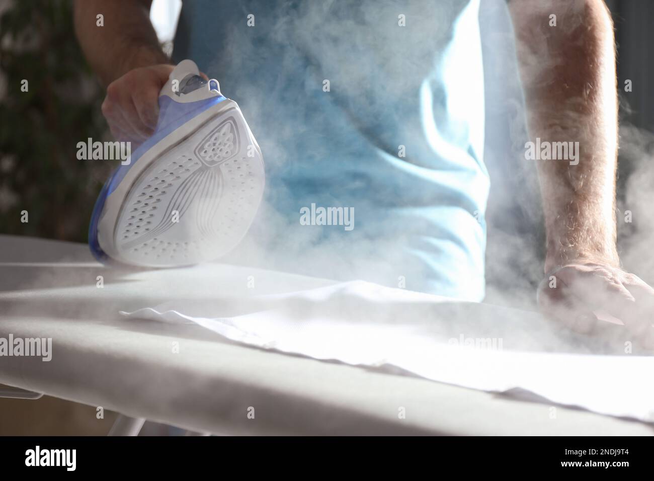 Man ironing clean shirt hi-res stock photography and images - Alamy