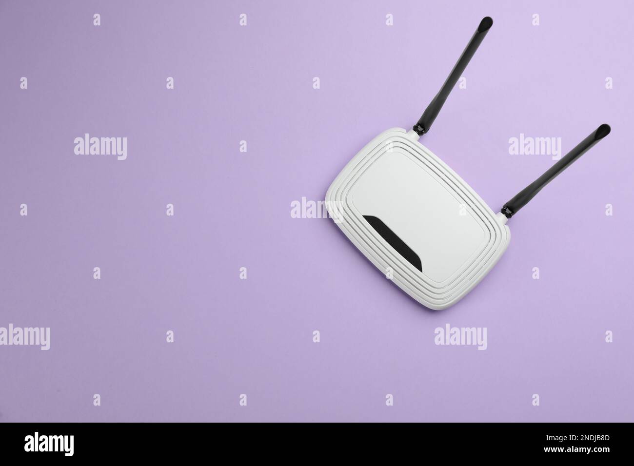 Modern Wi-Fi router on lilac background, top view. Space for text Stock ...