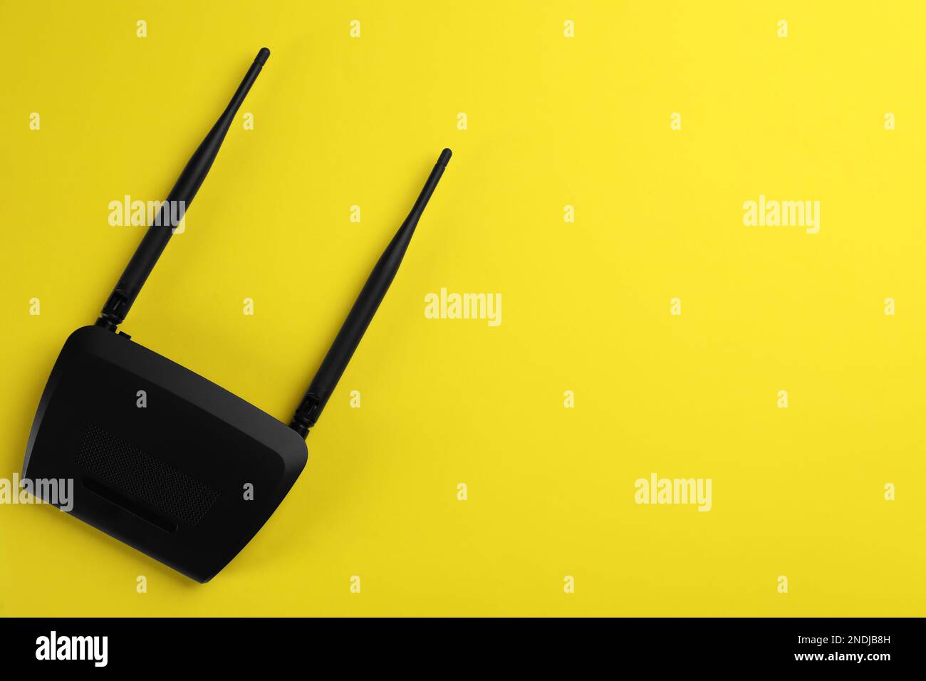 Modern Wi-Fi router on yellow background, top view. Space for text ...