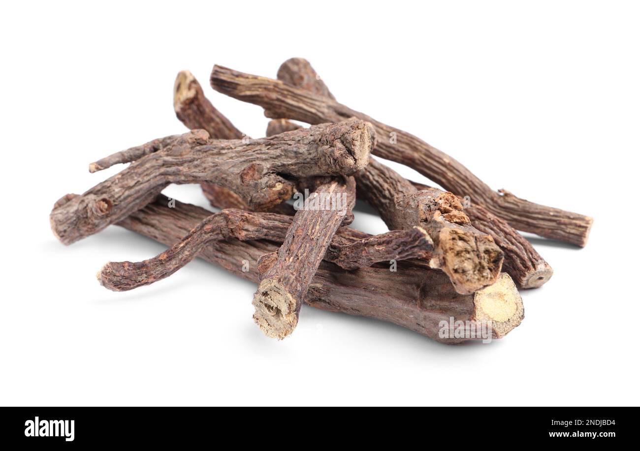 Dried sticks of liquorice root on white background Stock Photo - Alamy