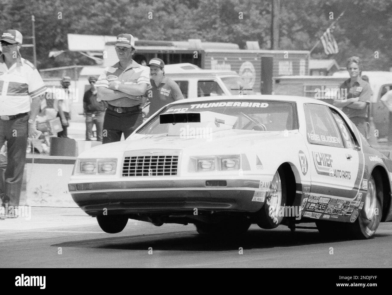 Driver Bob Glidden revs his car’s engine, lifting the front end as he ...