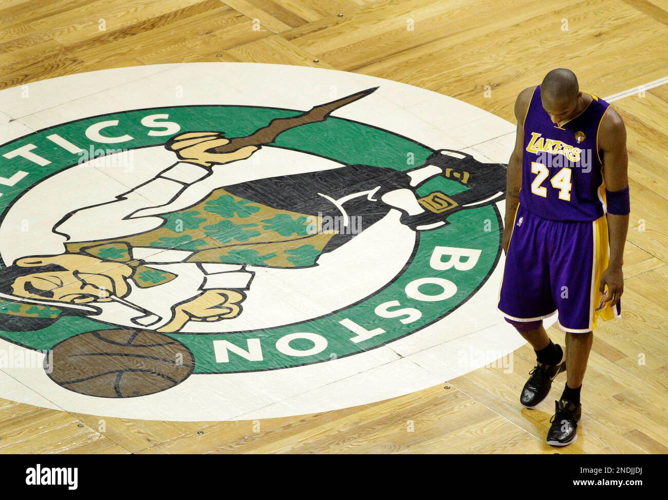 Los Angeles Lakers guard Kobe Bryant walks past the Boston Celtics logo ...