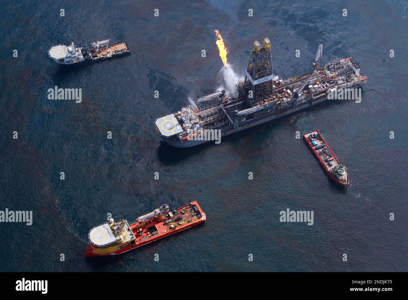 The Transocean Deepwater Discoverer drilling rig, center, and other ...