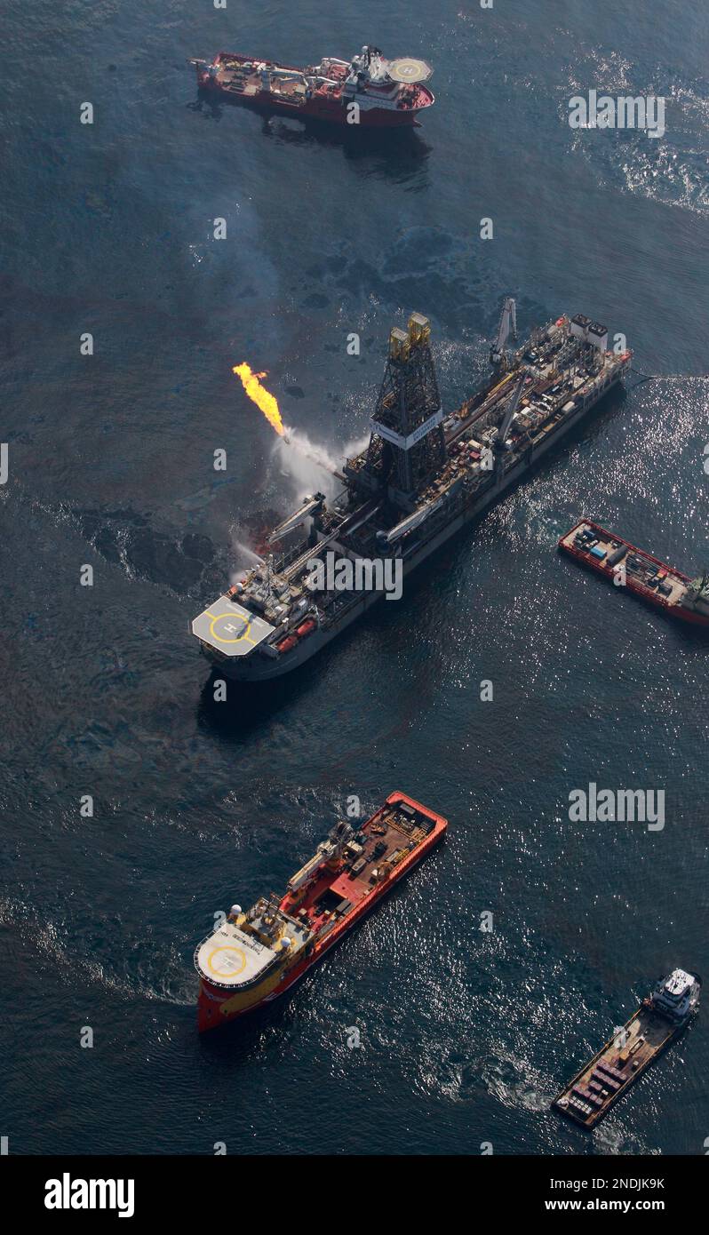 The Transocean Deepwater Discoverer drilling rig, center, and other ...