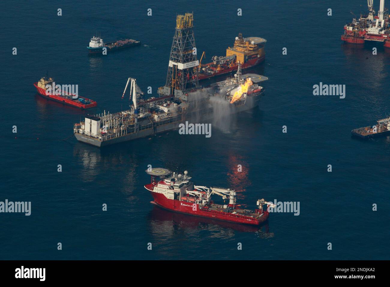 The Transocean Deepwater Discoverer drilling rig, center, and other ...