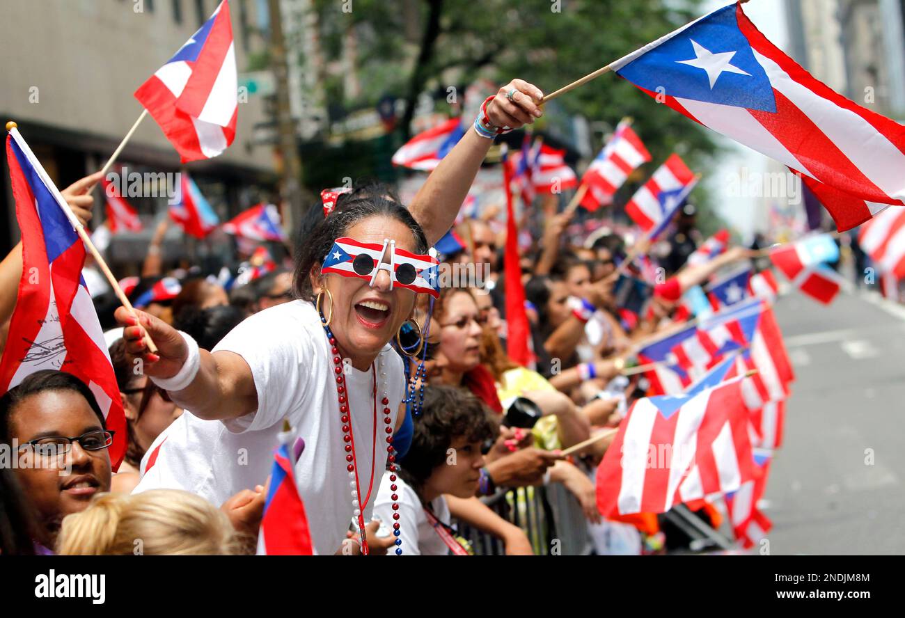 Puerto Rican flags wave as spectators line Fifth Avenue during the ...