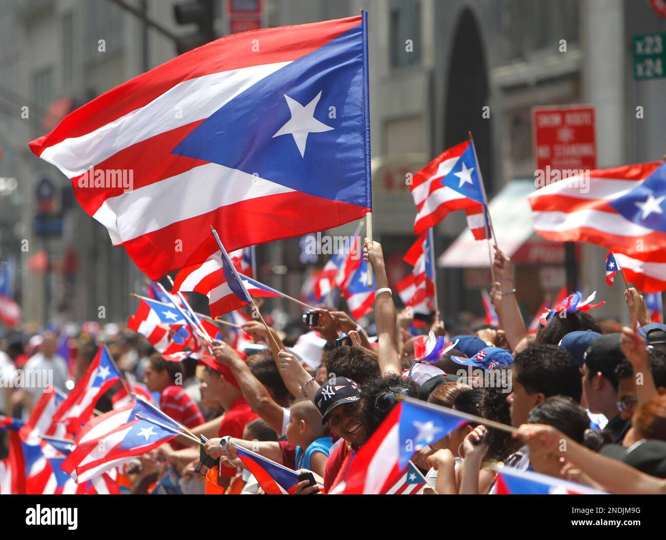Puerto Rican flags wave as spectators line Fifth Avenue during the ...
