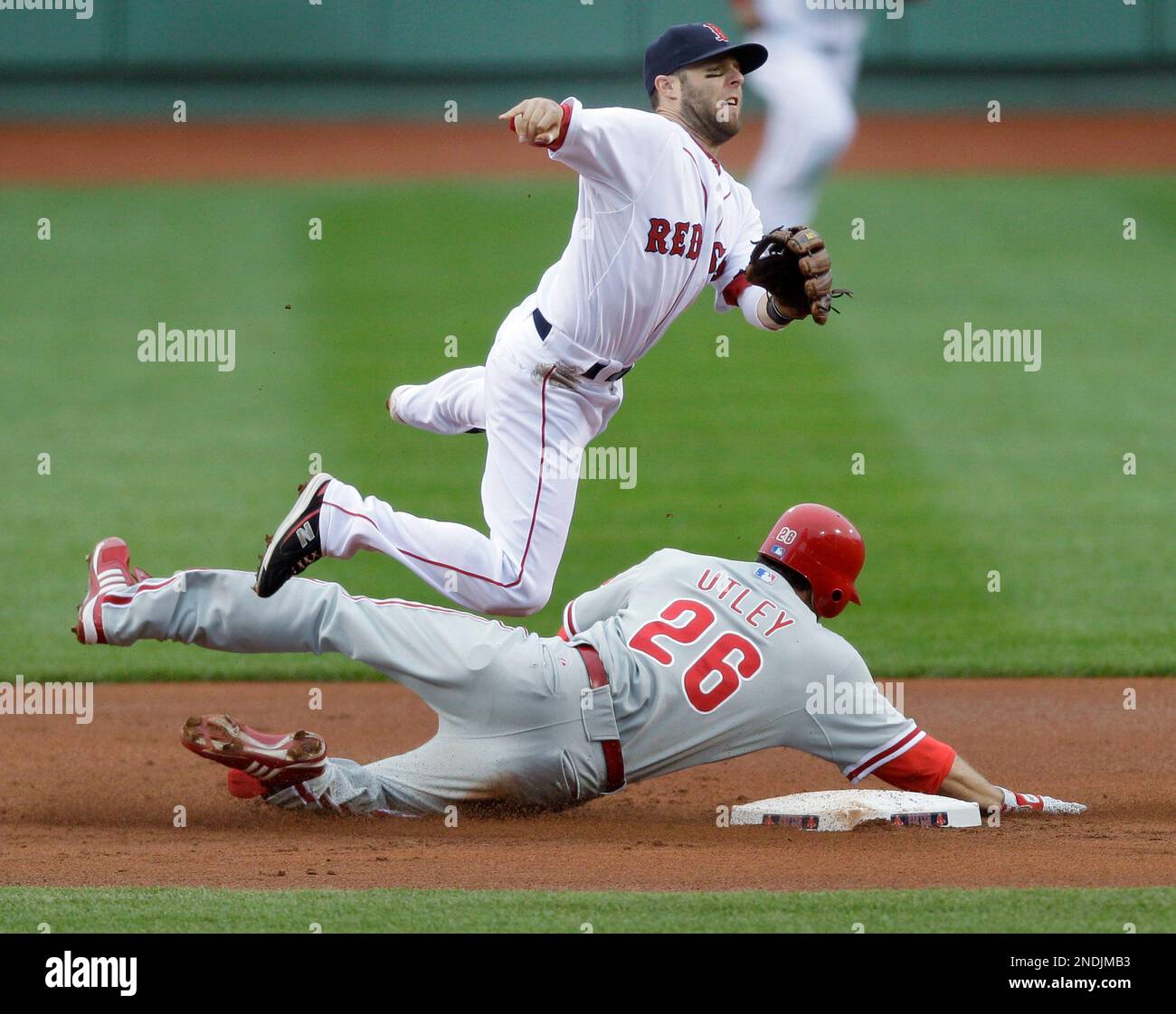 Boston Red Sox second baseman Dustin Pedroia, top, leaps as he forces ...